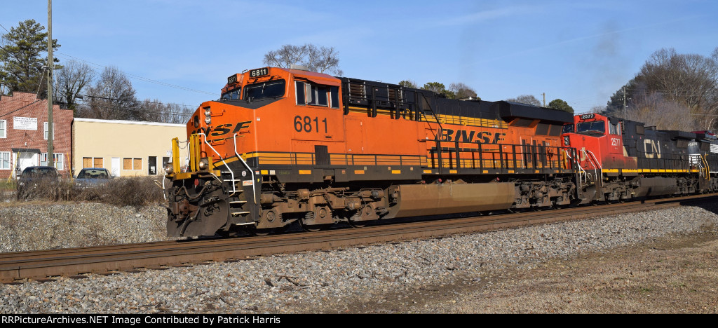 BNSF 6811 ES44C4 leads CN 2577 C44-9W and NS 8713 C40-8 with an NS unit grain train westbound ...